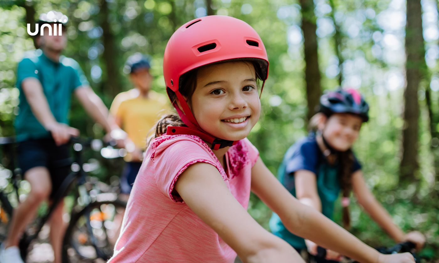 How do I teach my child how to turn the bike with control while cycling?
